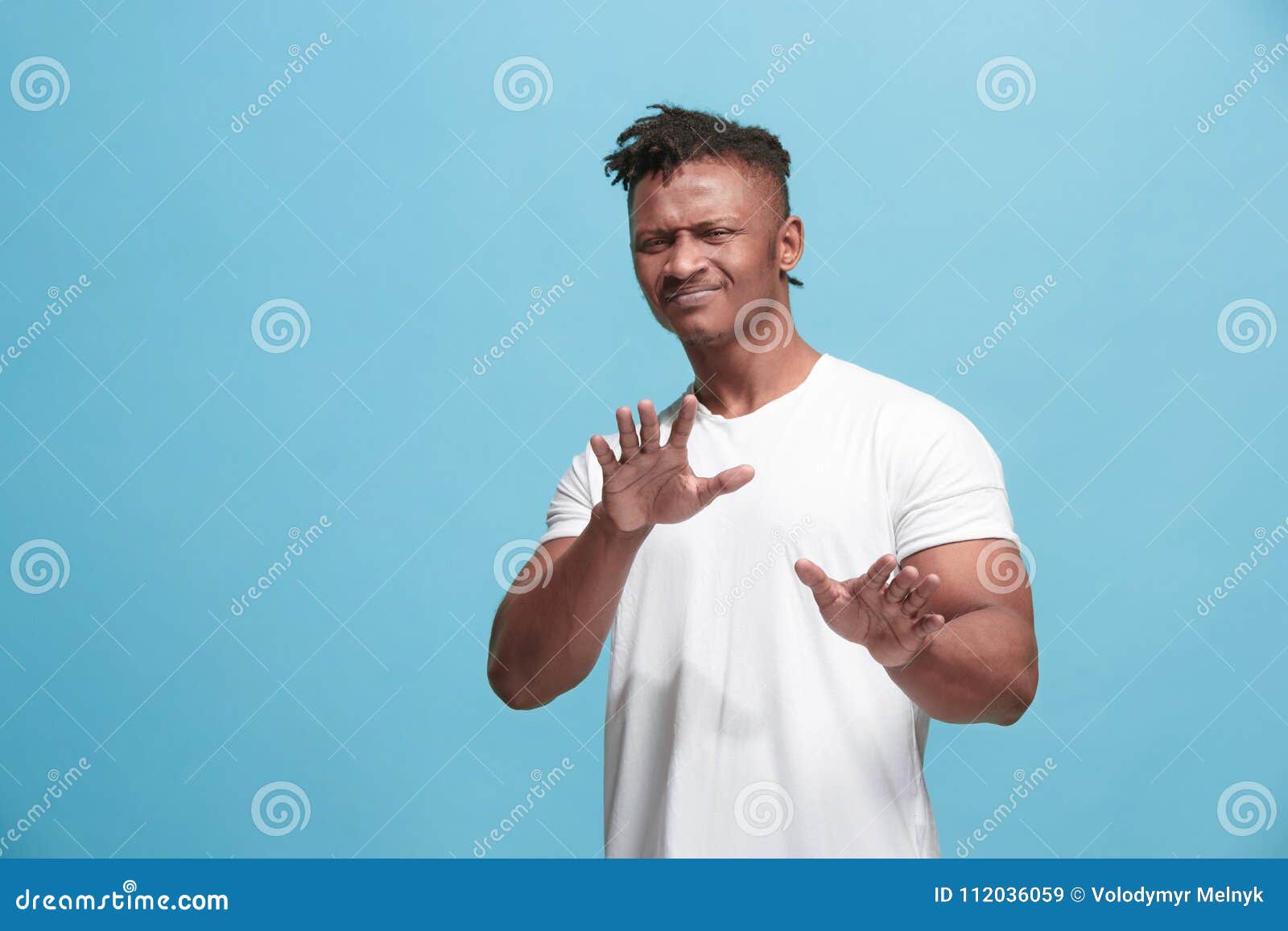 Young Man with Disgusted Expression Repulsing Something, on the Blue ...