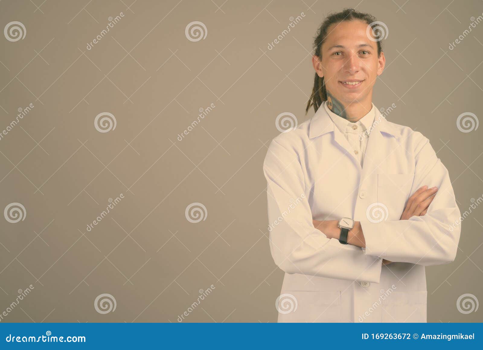 Young Man Doctor with Dreadlocks Against Gray Background Stock Photo ...