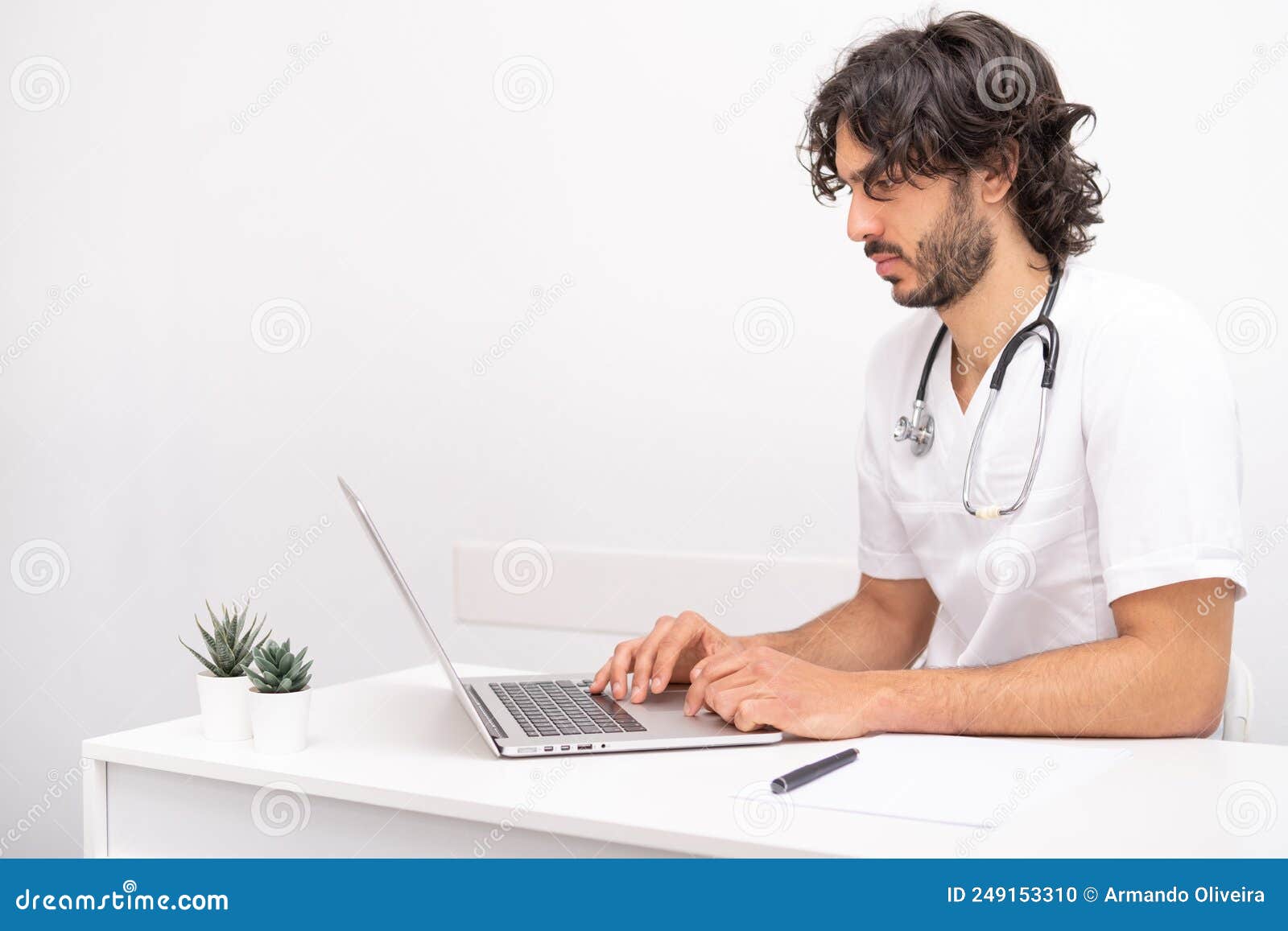 Young Man Doctor with Stethoscope Using Computer Laptop Stock Photo ...