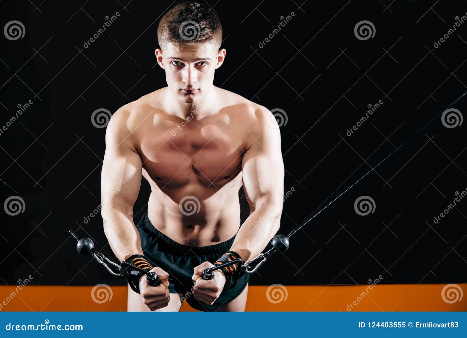 Young Man Does Hand-cutting on the Simulator in the Gym. Exercise for ...