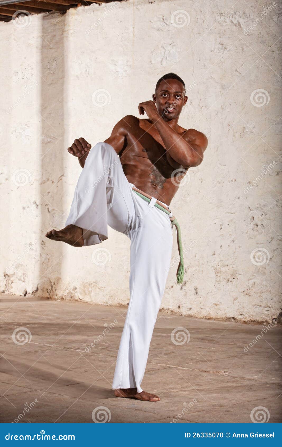 Young Man Does a Knee Kick stock photo. Image of acrobatic - 26335070