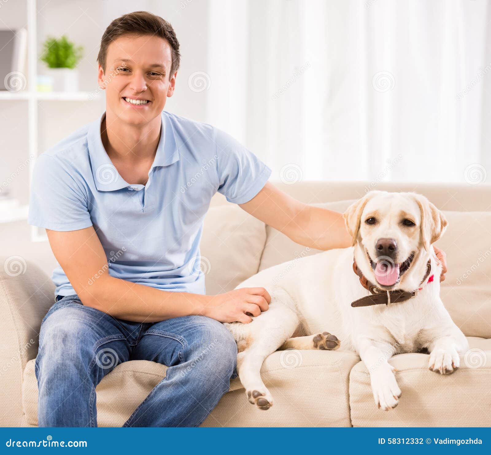 Young man with dog stock photo. Image of lifestyle, apartment - 58312332