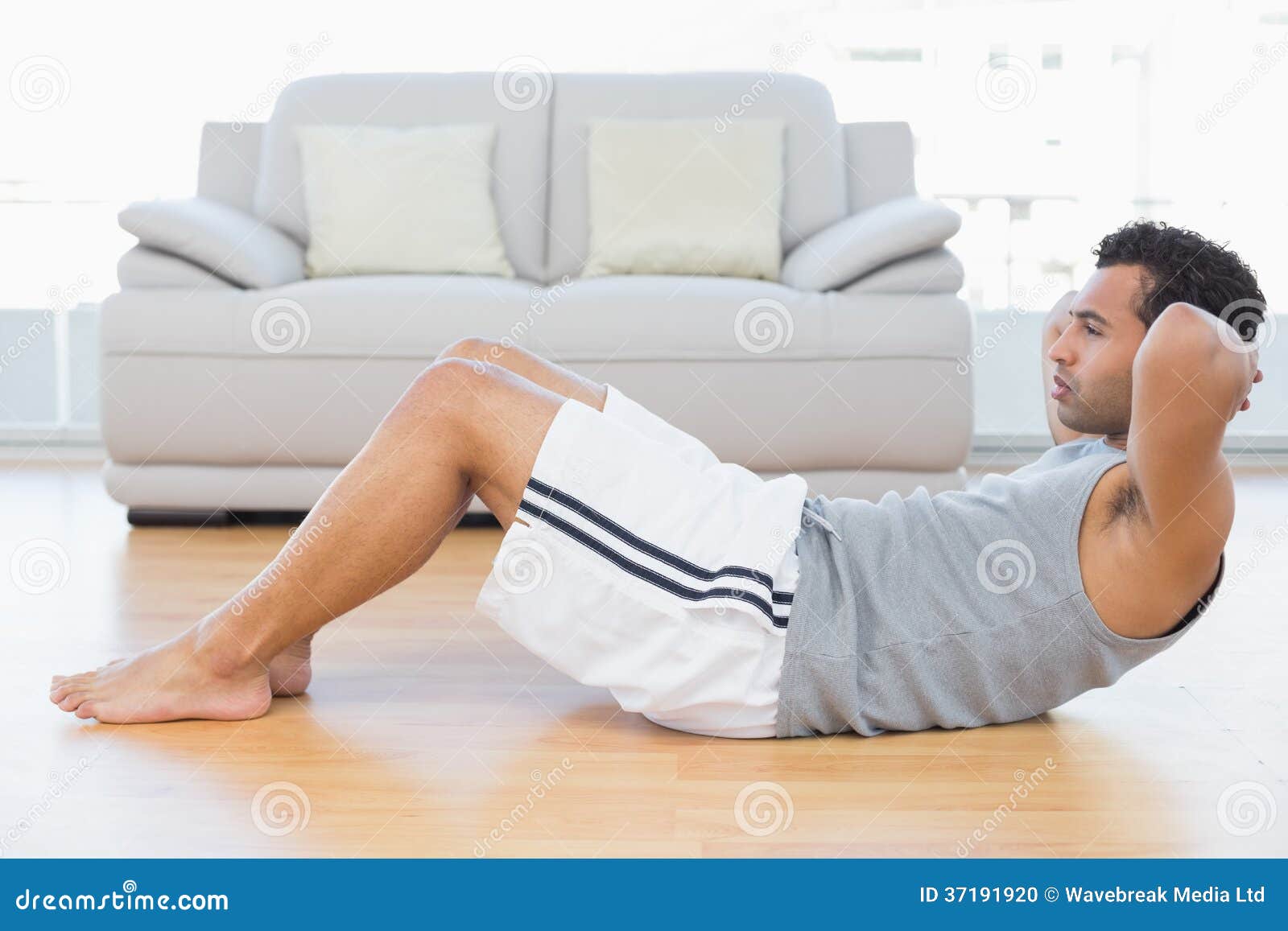 Young Man Doing Abdominal Crunches in the Living Room Stock Photo ...