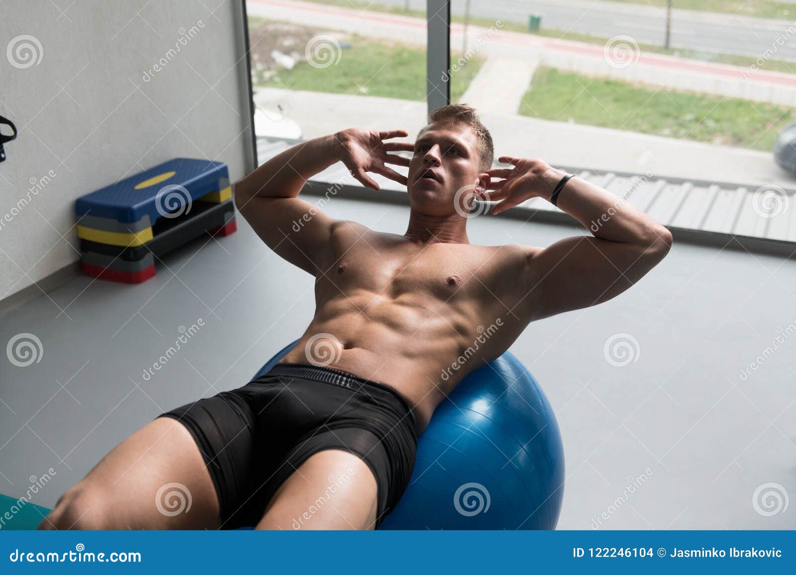 Young Man Doing Abdominal Exercise on Ball Stock Photo - Image of ...