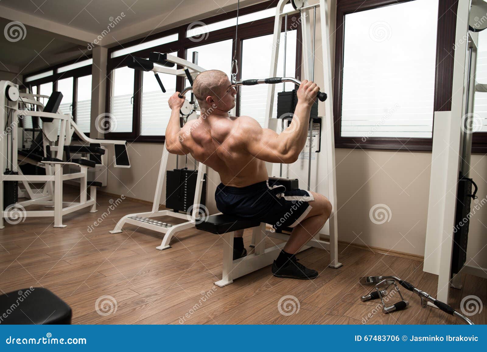 Young Man Doing Back Exercise on a Machine Stock Photo - Image of back ...