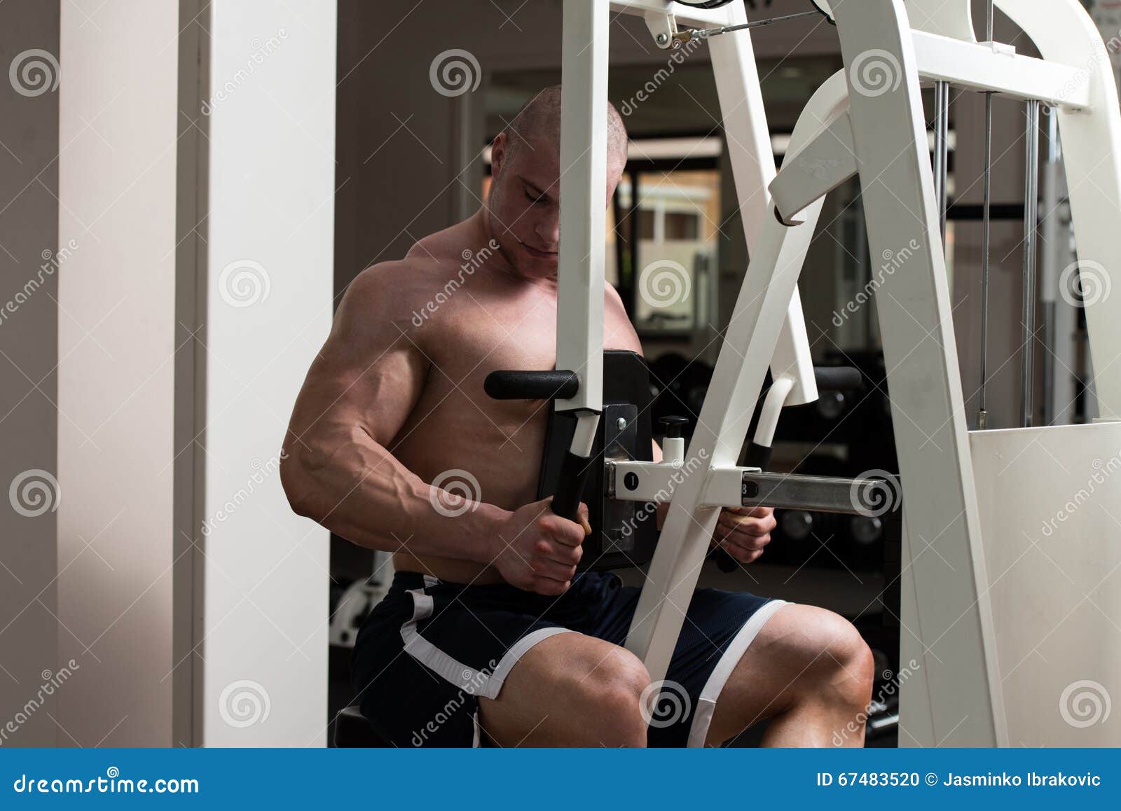Young Man Doing Back Exercise on a Machine Stock Photo - Image of ...