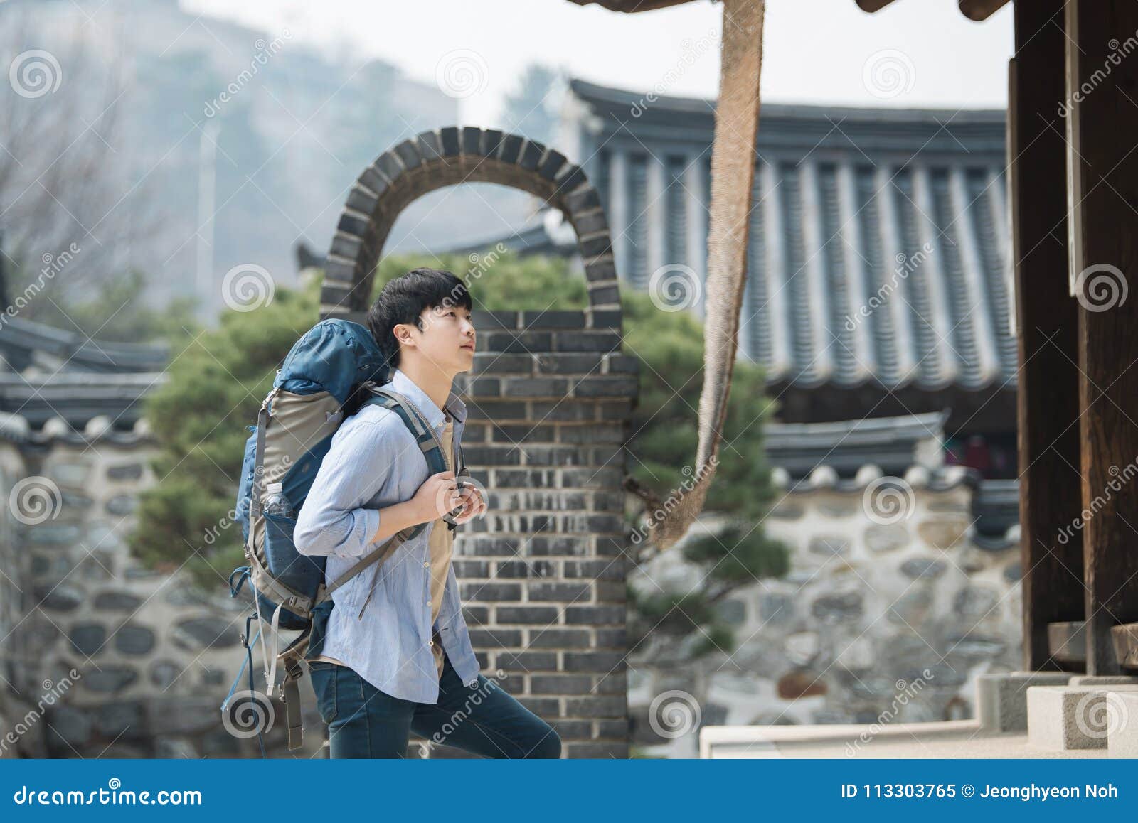 Young Man Doing a Backpacking Trip in a Korean Traditional House. Stock ...