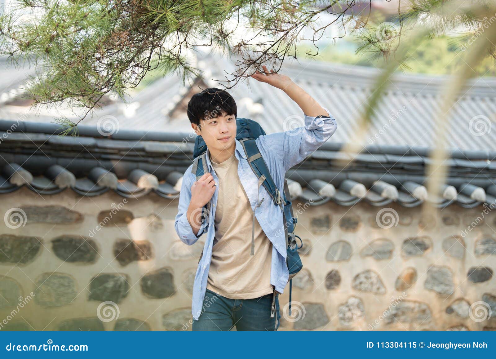 Young Man Doing a Backpacking Trip in a Korean Traditional House. Stock ...
