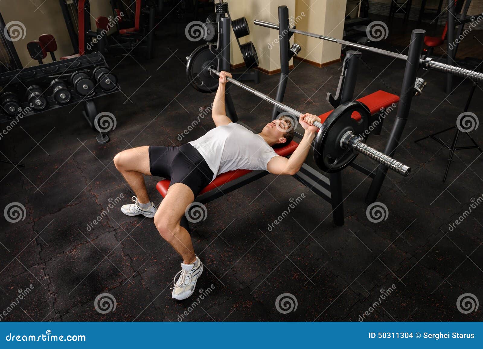Young Man Doing Bench Press Workout in Gym Stock Photo - Image of ...