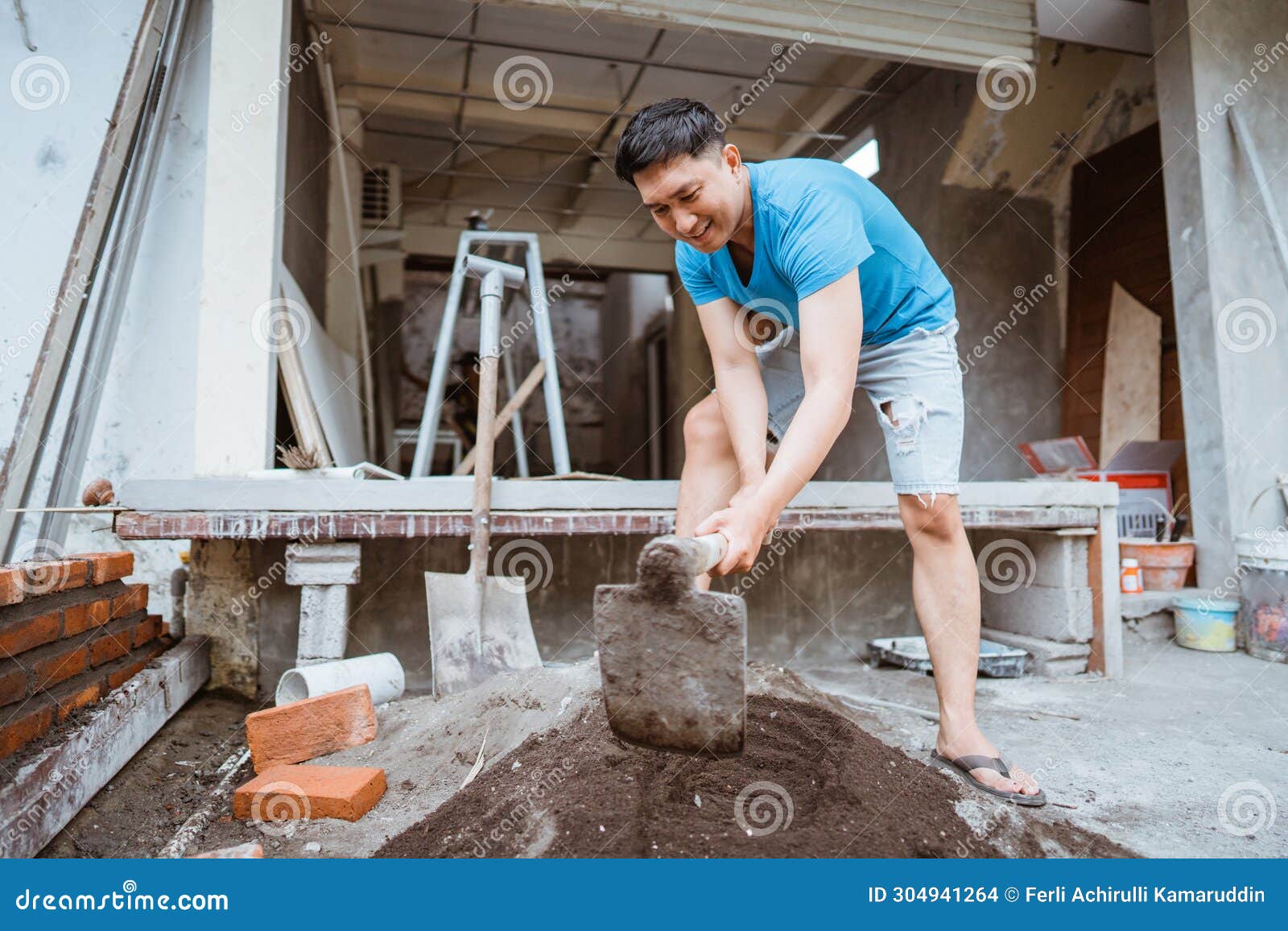 Young Man Doing Construction Work Mixing Cement Using a Hoe Stock Photo ...