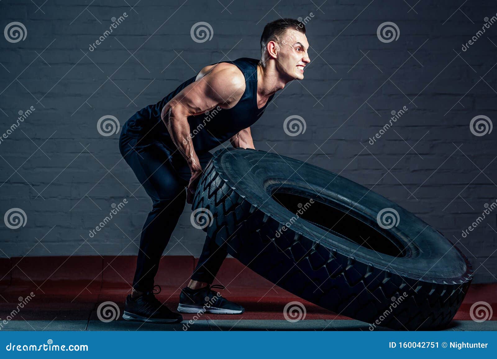 Young Man Doing Exercises with a Tire in the Gym Stock Image - Image of ...