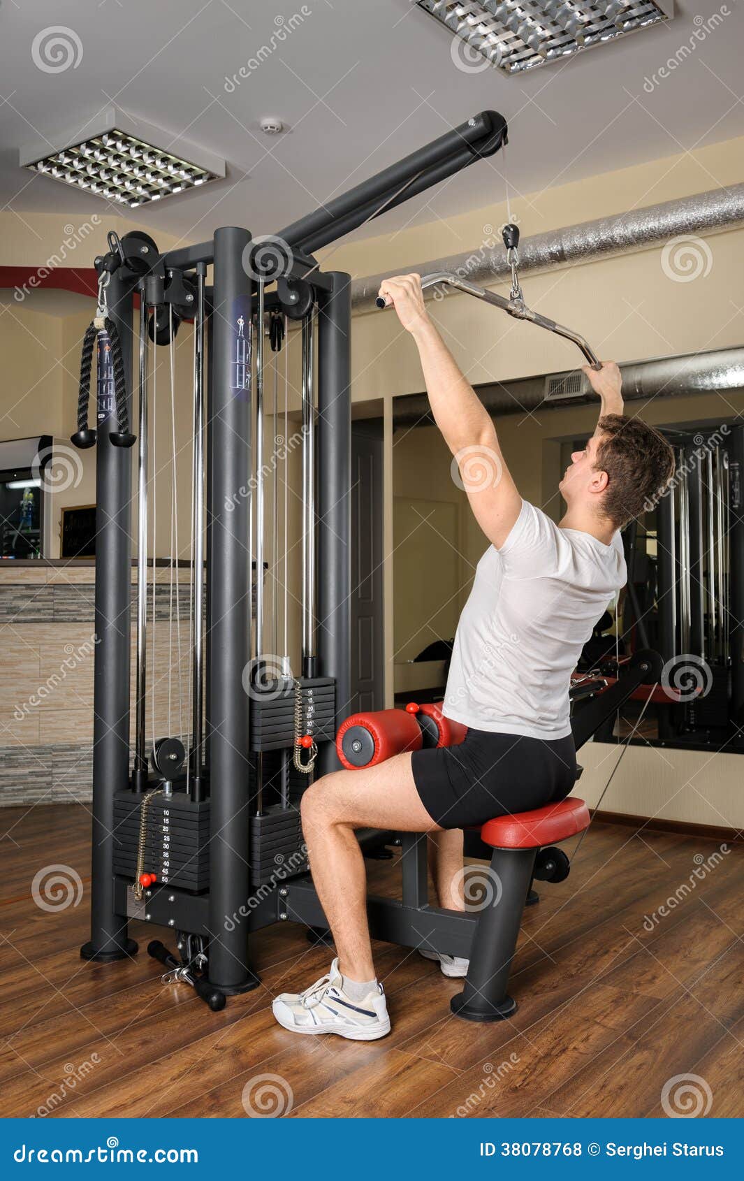 Young Man Doing Lats Pull-down Workout in Gym Stock Photo - Image of ...