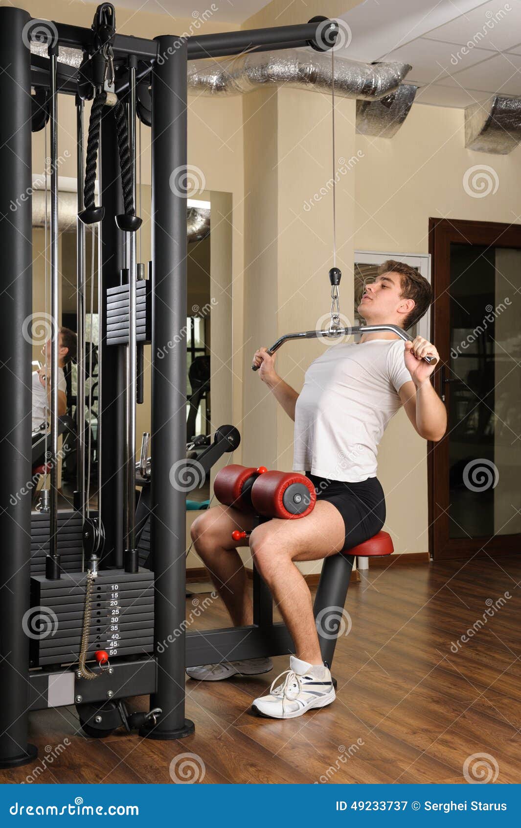 Young Man Doing Lats Pull-down Workout Stock Image - Image of equipment ...