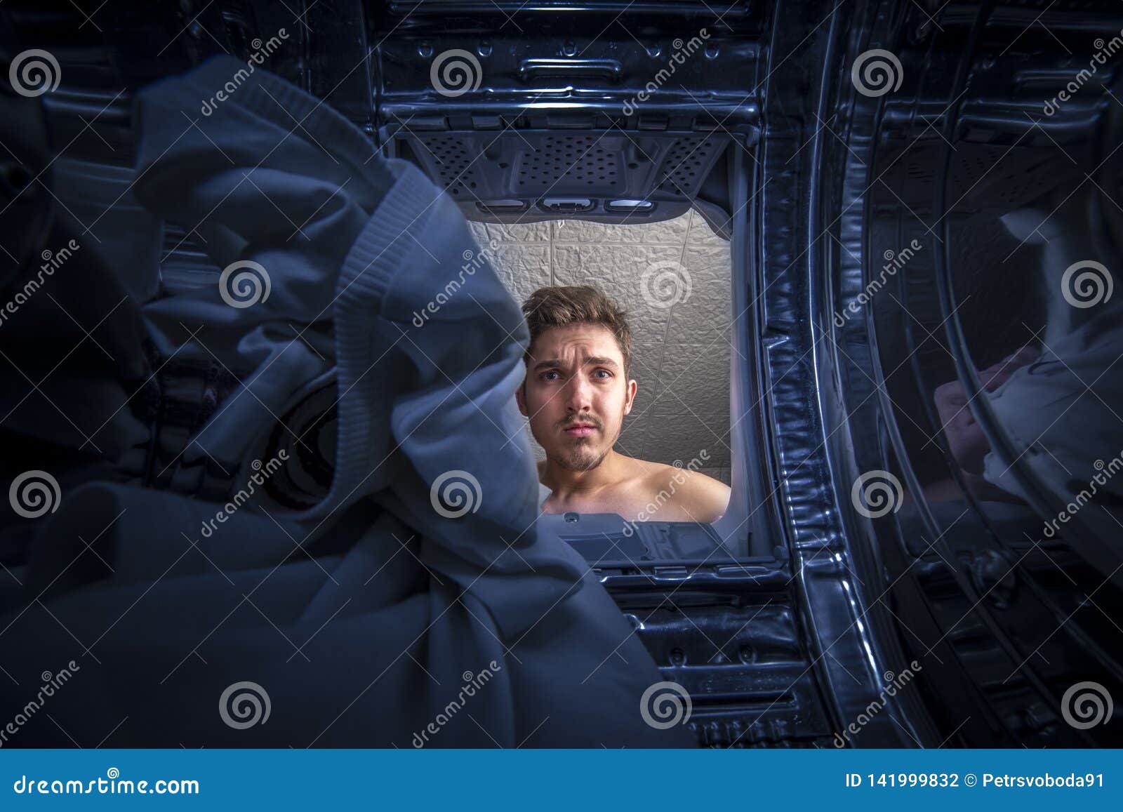 Young Man Doing Laundry View from the Inside of Broken Washing Machine ...