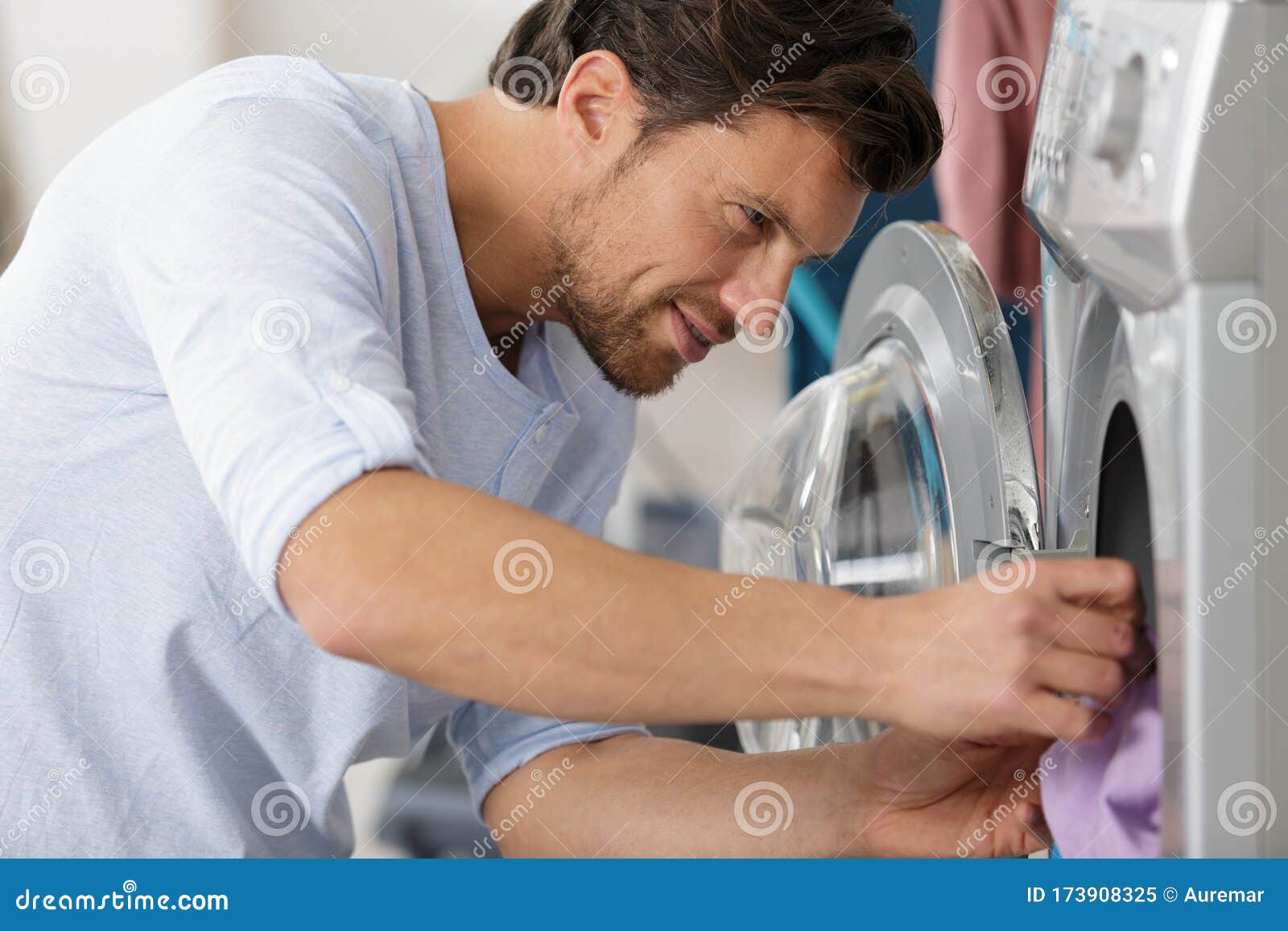 Young man doing laundry stock image. Image of wash, clothing - 173908325