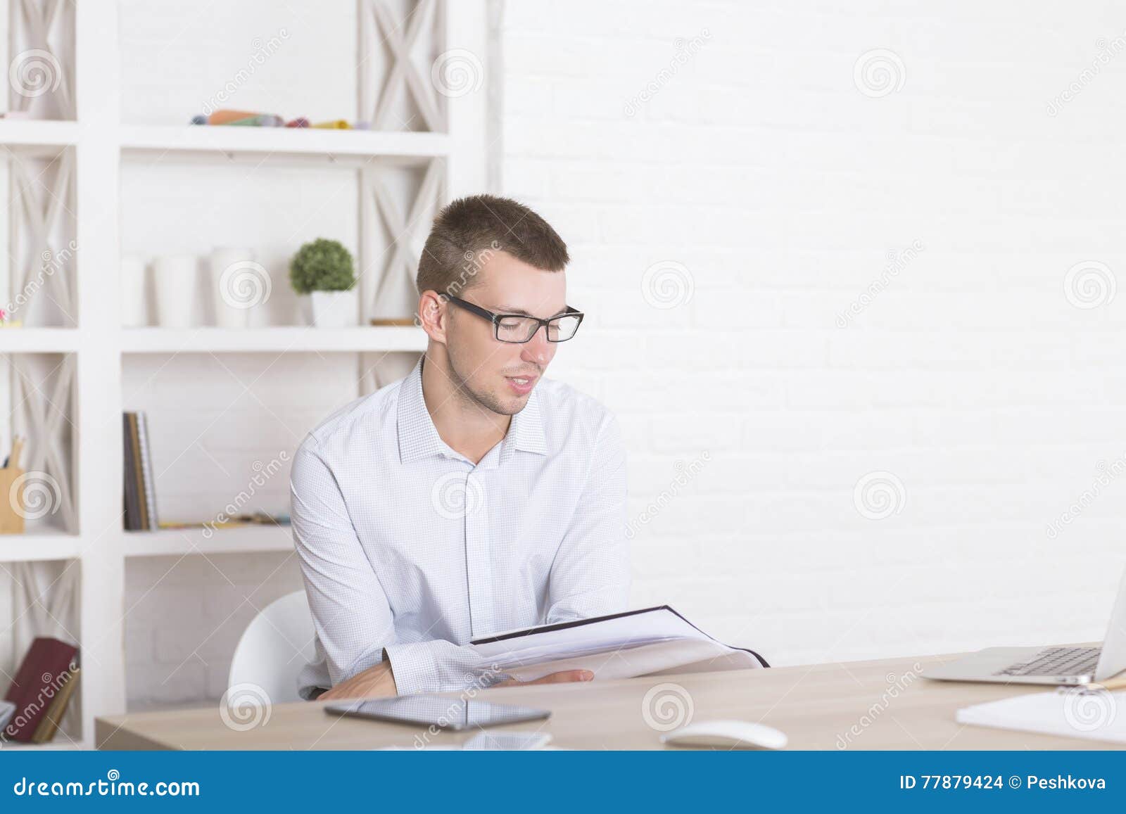 Young man doing paperwork stock photo. Image of adult - 77879424