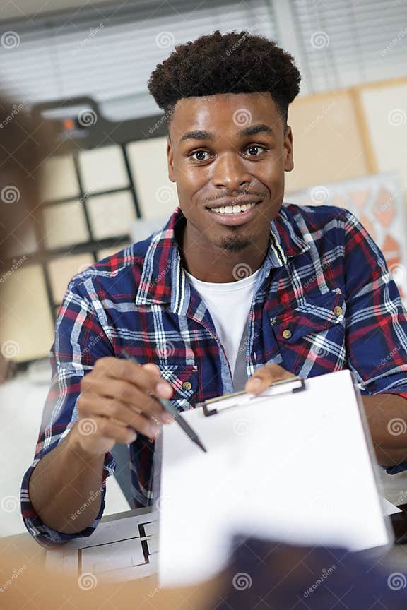 Young Man Doing Paperwork at Office Desk Stock Image - Image of adult ...