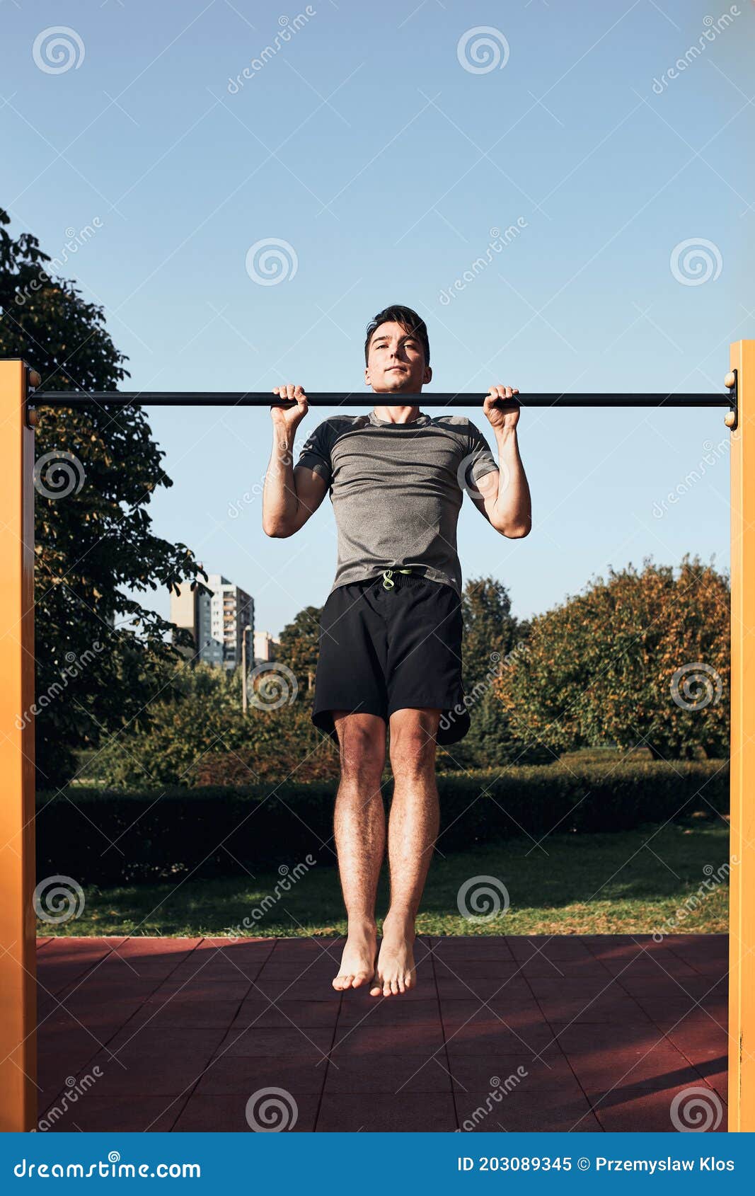 Young Man Doing Pull-ups during His Workout in a Modern Calisthenics ...