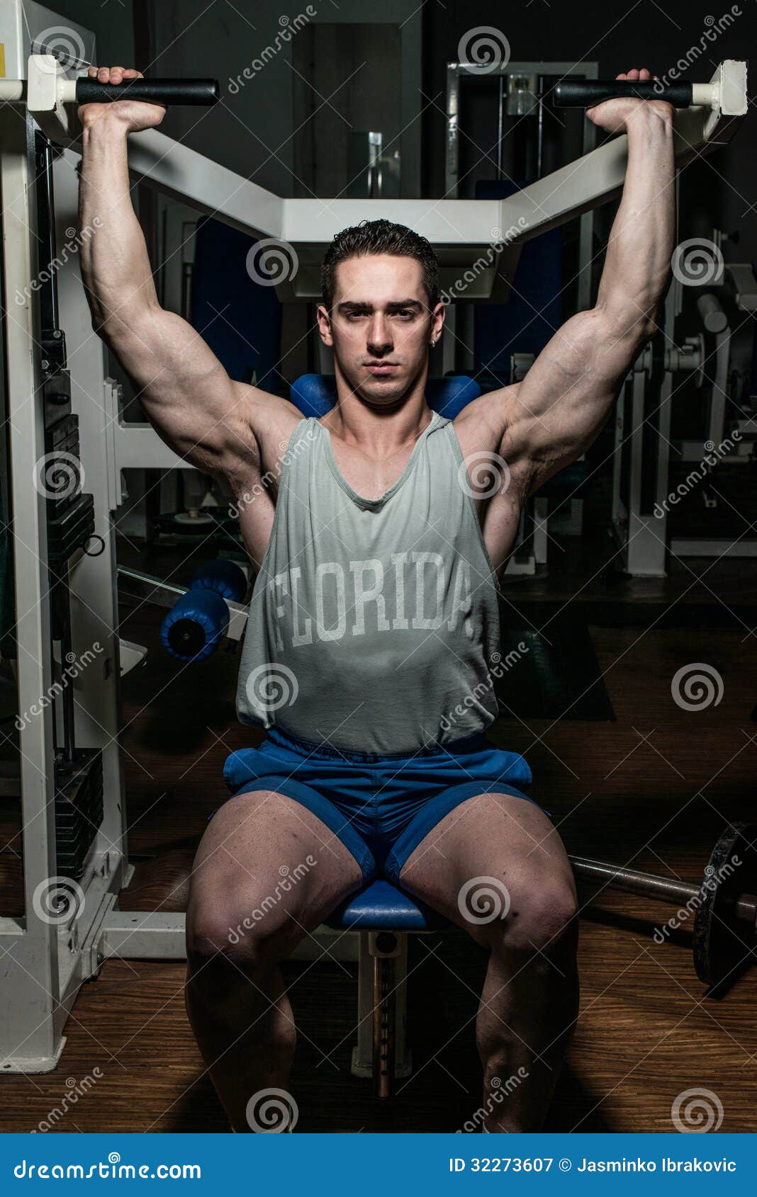 Young Man Doing Shoulder Press on Machine in Gym Stock Image - Image of ...