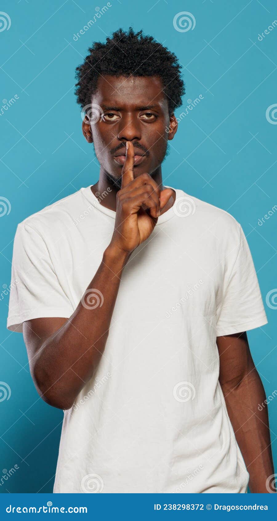 Young Man Doing Silence Gesture with Finger on Mouth Stock Photo ...