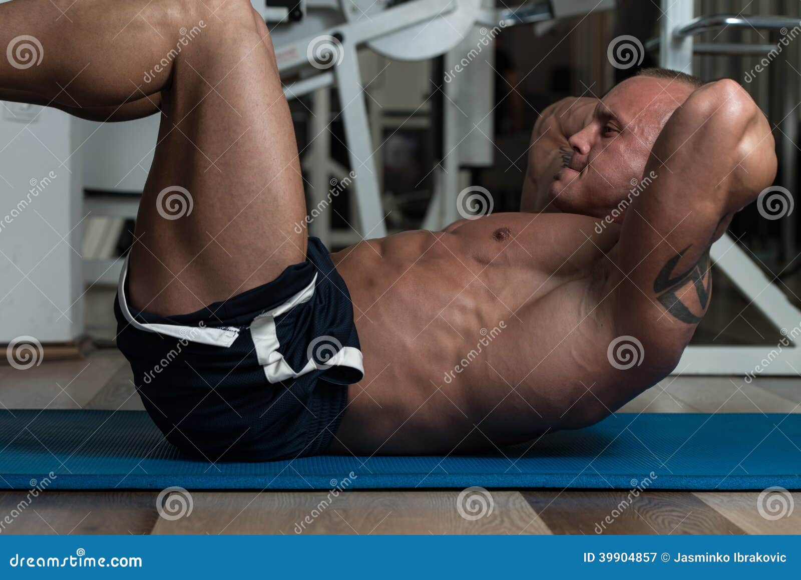 Young Man Doing Sit-Ups on Exercise Mat Stock Image - Image of ...