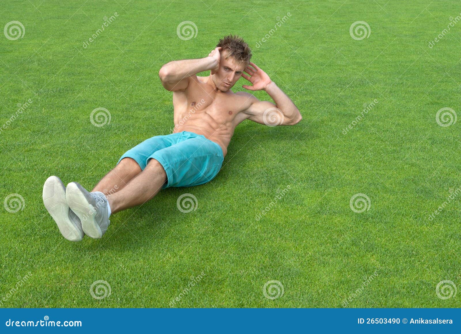 Young Man Doing Sit-ups on Green Grass Stock Photo - Image of ...