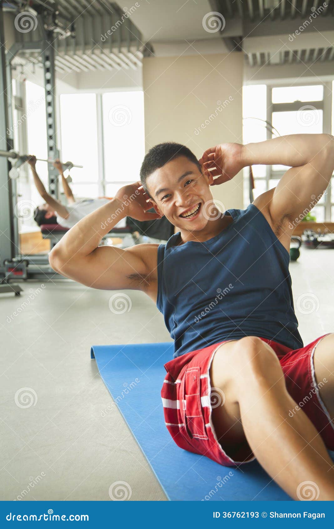 Young Man Doing Sit-ups in the Gym Stock Image - Image of looking ...