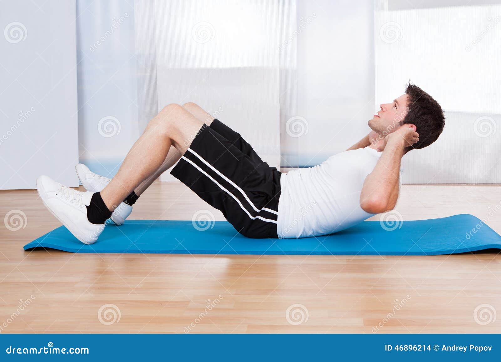 Young man doing sit-ups stock photo. Image of caucasian - 46896214