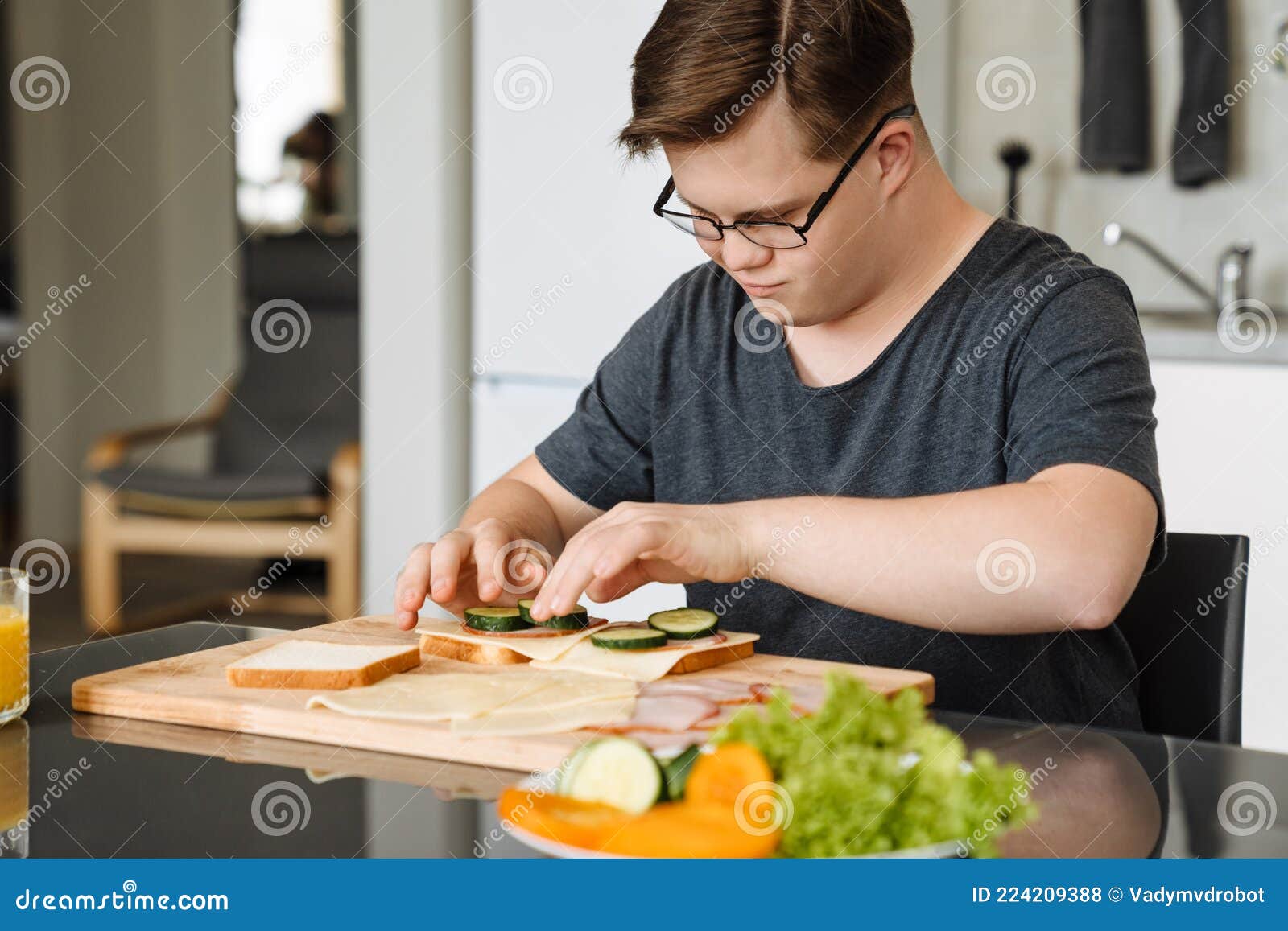 Young Man with Down Syndrome Making Sandwiches in Kitchen Stock Photo ...