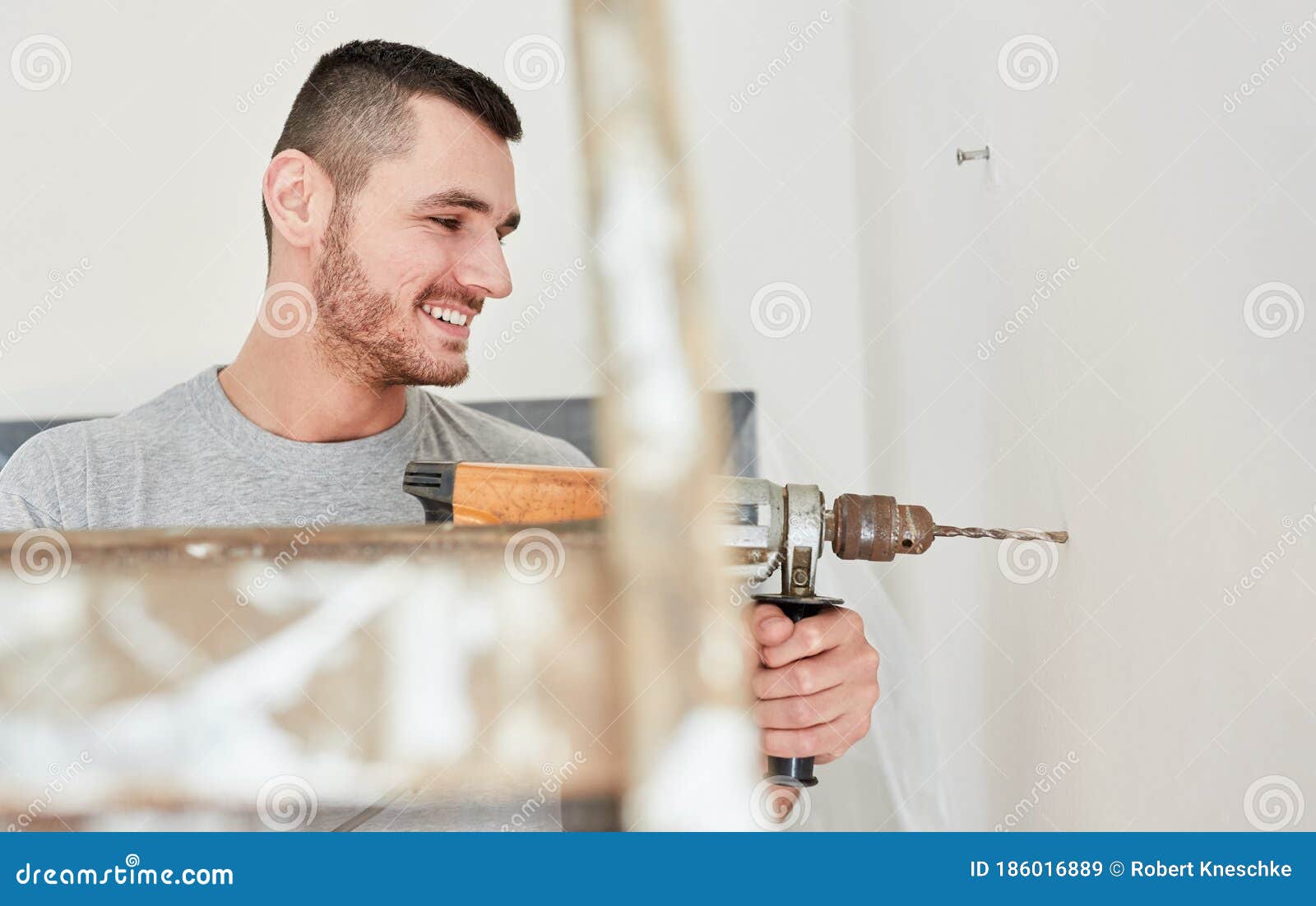 Young Man with Drill Drilling at the Hole Stock Image - Image of person ...