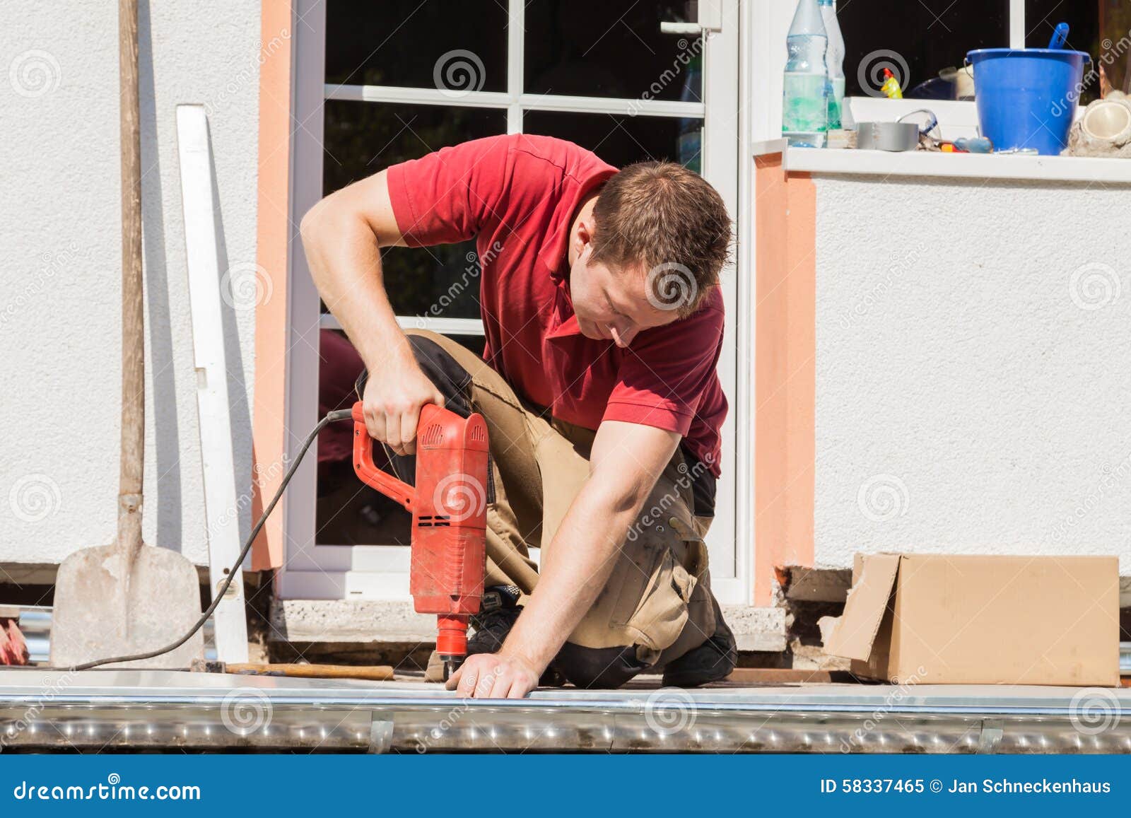 A Young Man Drilling a Hole Stock Image - Image of hammering, build ...