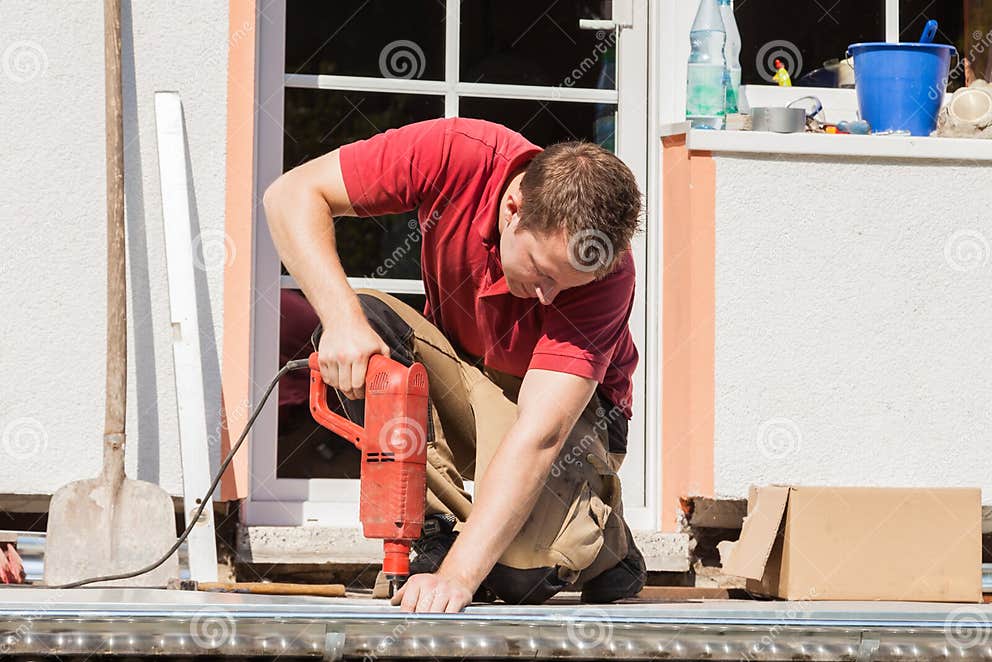 A Young Man Drilling a Hole Stock Image - Image of hammering, build ...