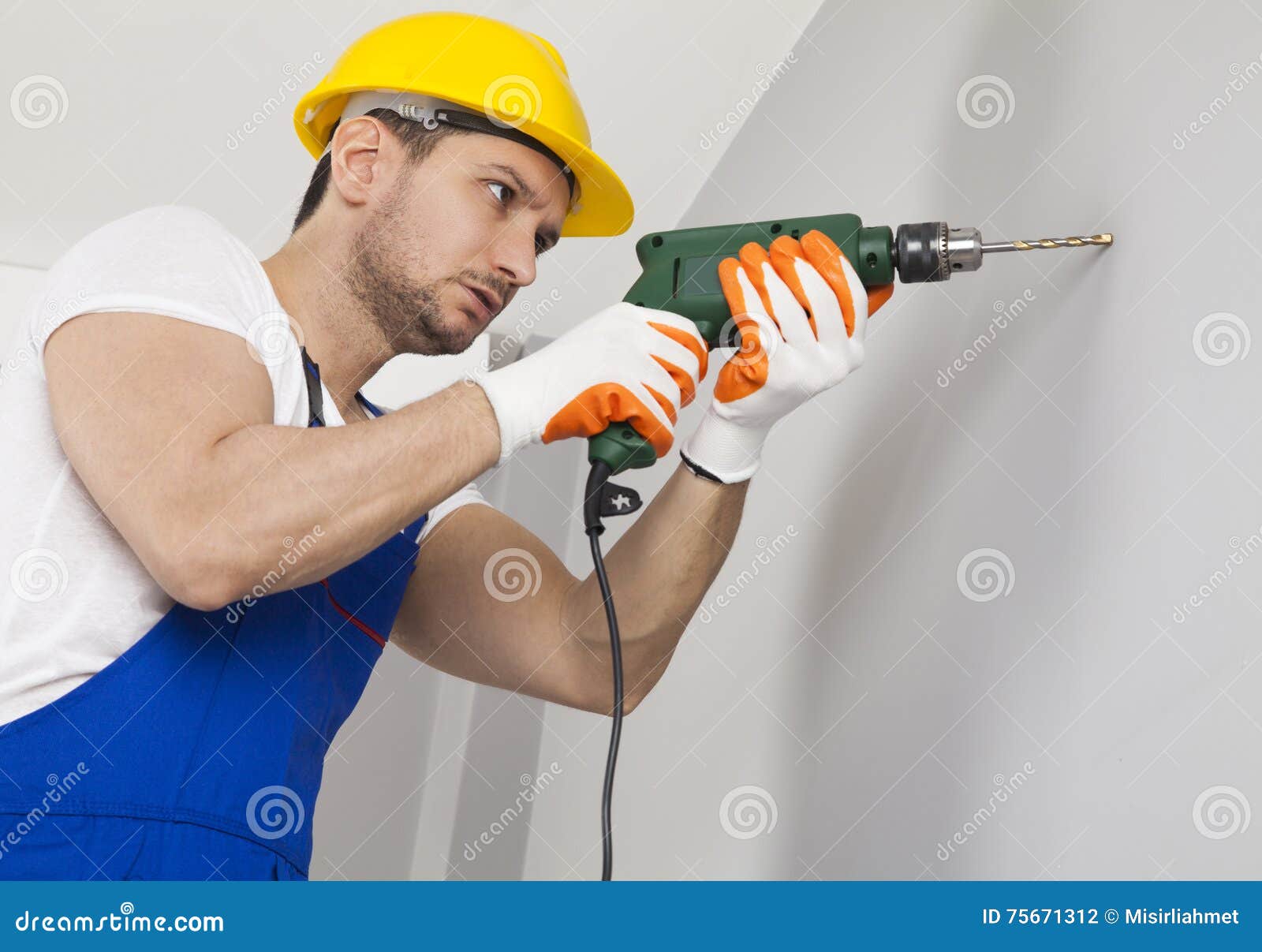 Young Man Drilling Hole in Wall Stock Photo - Image of protective ...