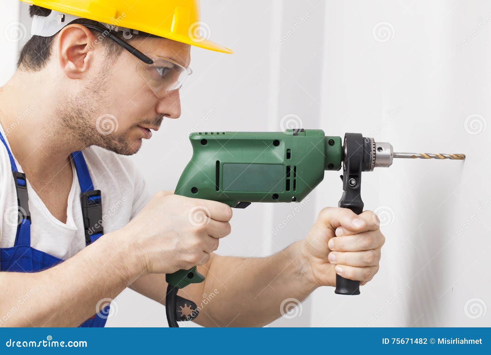 Young Man Drilling Hole in Wall Stock Photo - Image of contractor ...