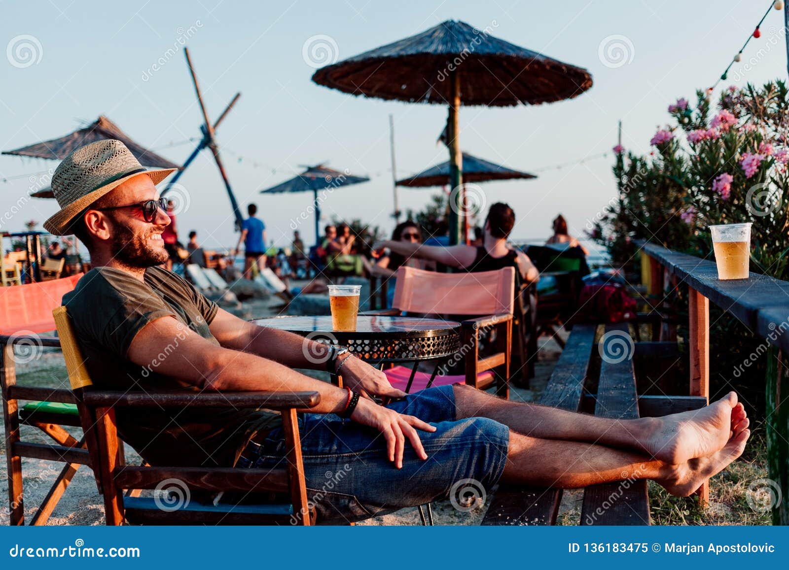Young Man Drinking Beer in a Beach Bar Stock Image - Image of dreaming ...
