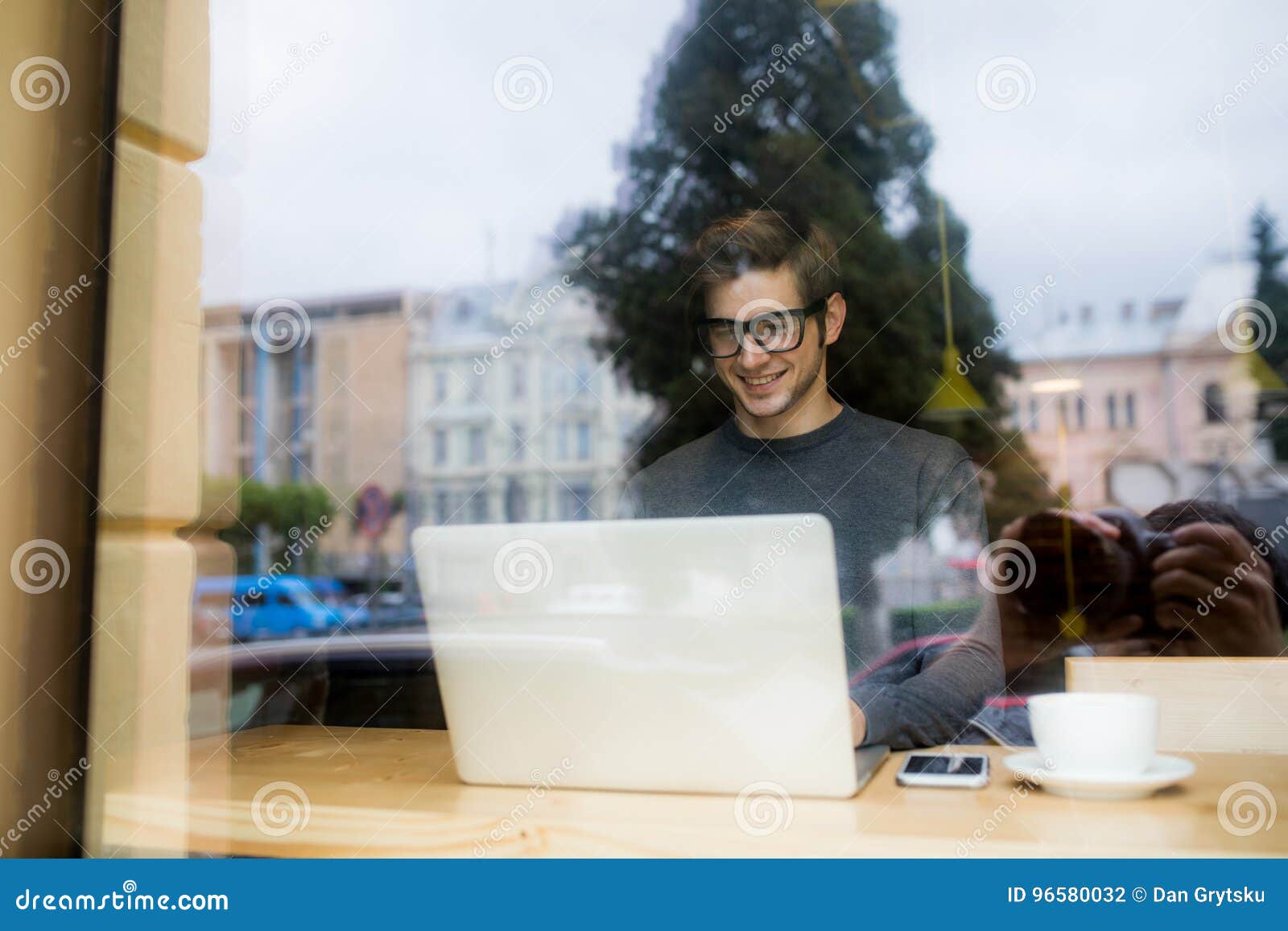 Young Man Drinking Coffee in Cafe Using Computer Stock Photo - Image of ...