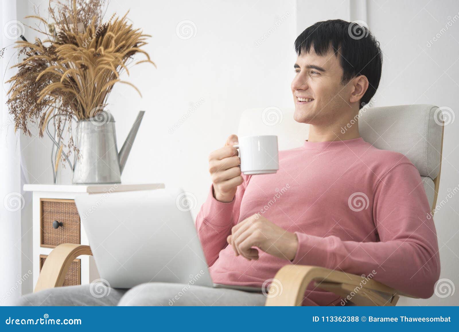 Young Man Drinking Coffee and Using Computer in the Morning Time Stock ...