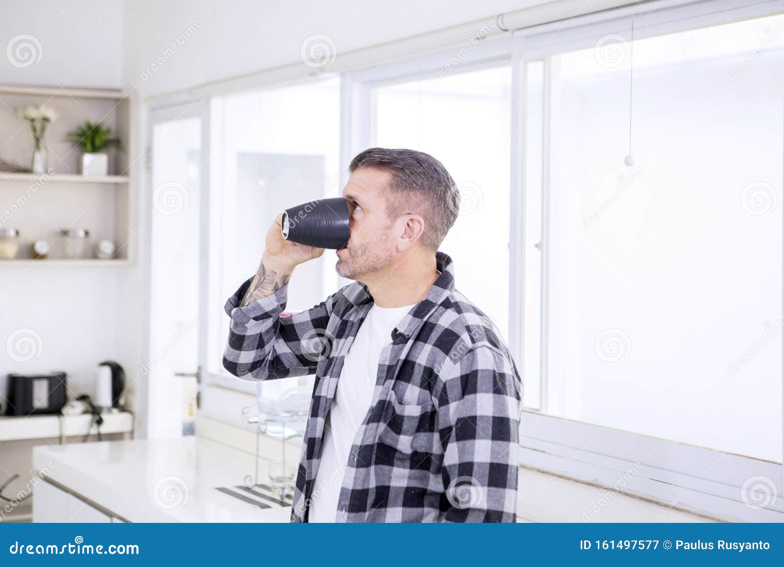 Young Man Drinking a Cup of Coffee in the Kitchen Stock Image - Image ...