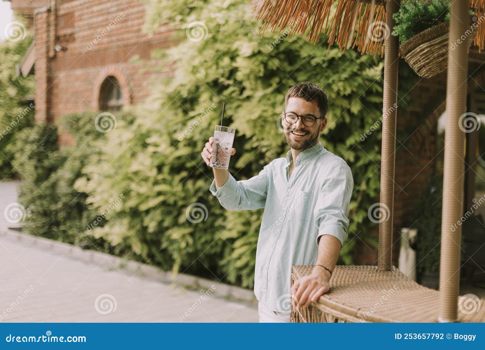 Young Man Drinking Fresh Cold Lemonade at the Pool Bar Stock Photo ...