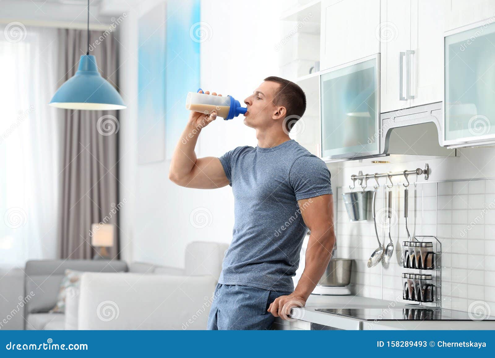 Young Man Drinking Protein Shake in Kitchen Stock Image - Image of care ...