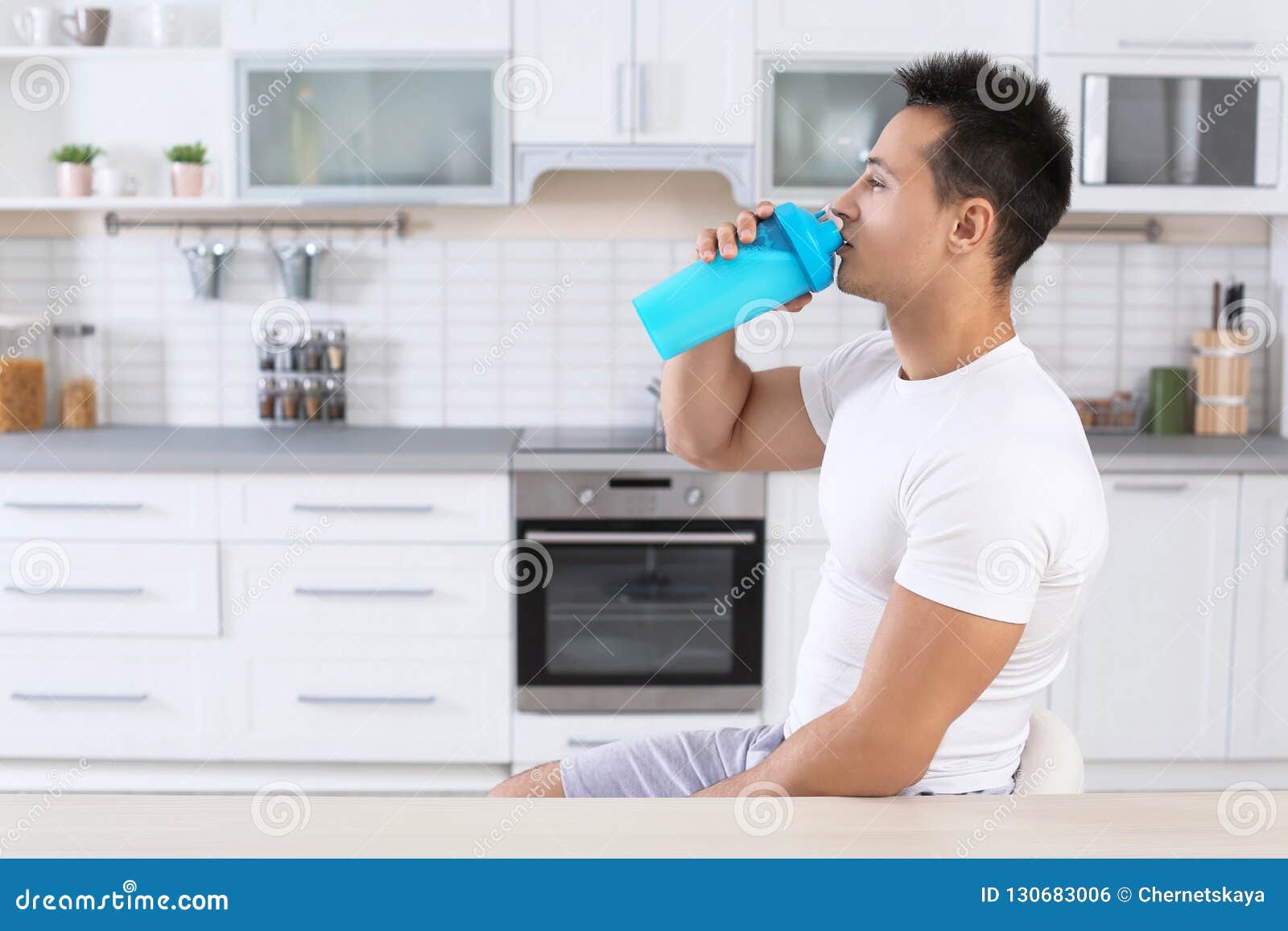 Young Man Drinking Protein Shake in Kitchen Stock Photo - Image of ...