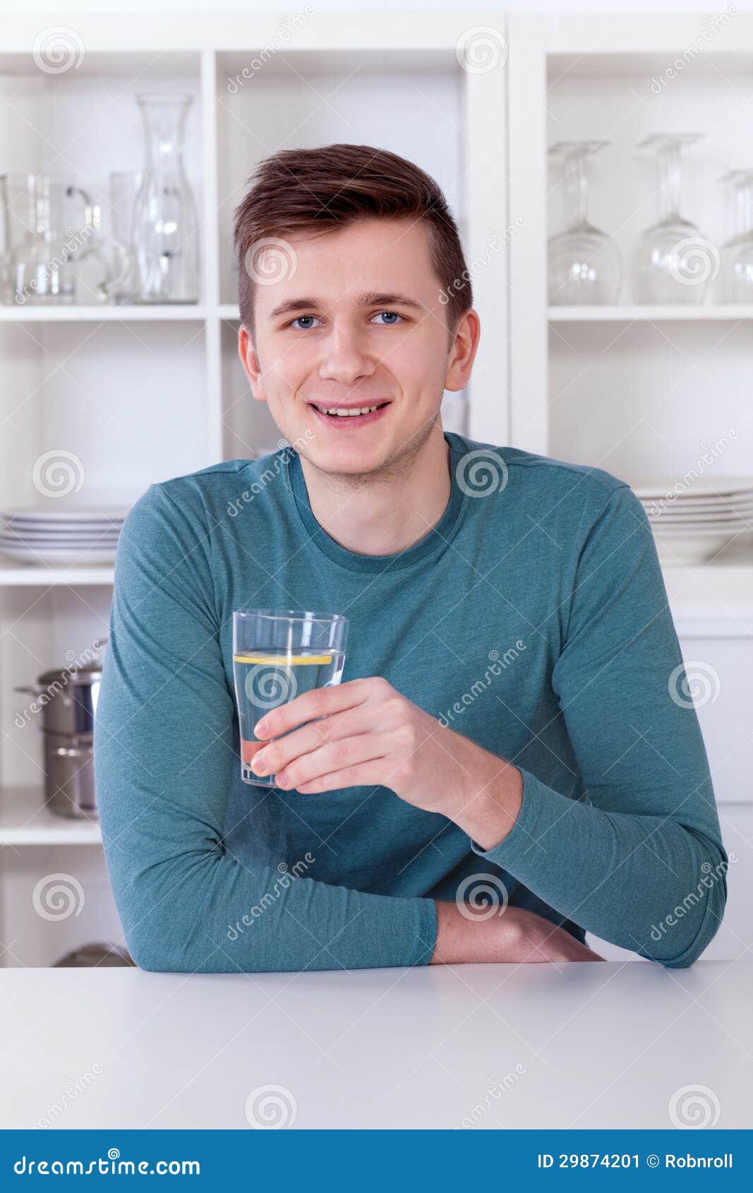 Young Man Drinking Refreshing Lemonade in His Kitchen Stock Image ...