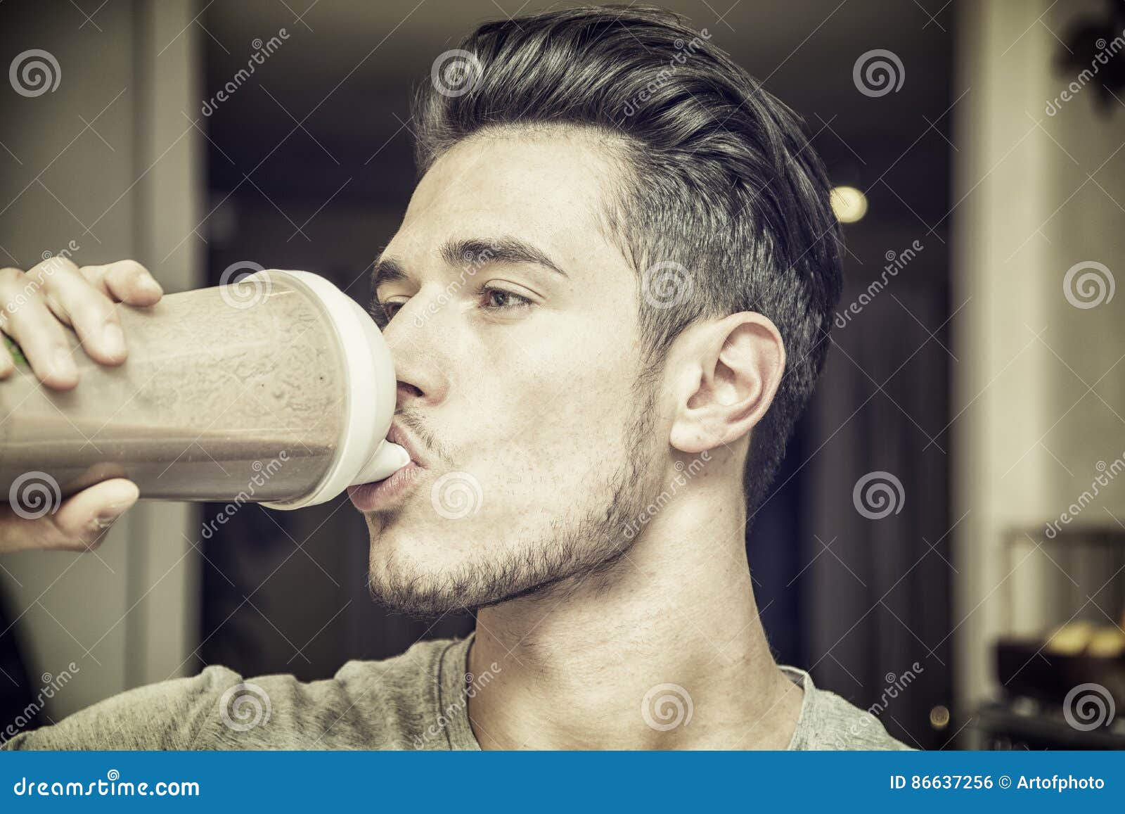 Young Man Drinking a Smoothie Drink or a Protein Shake Stock Photo ...