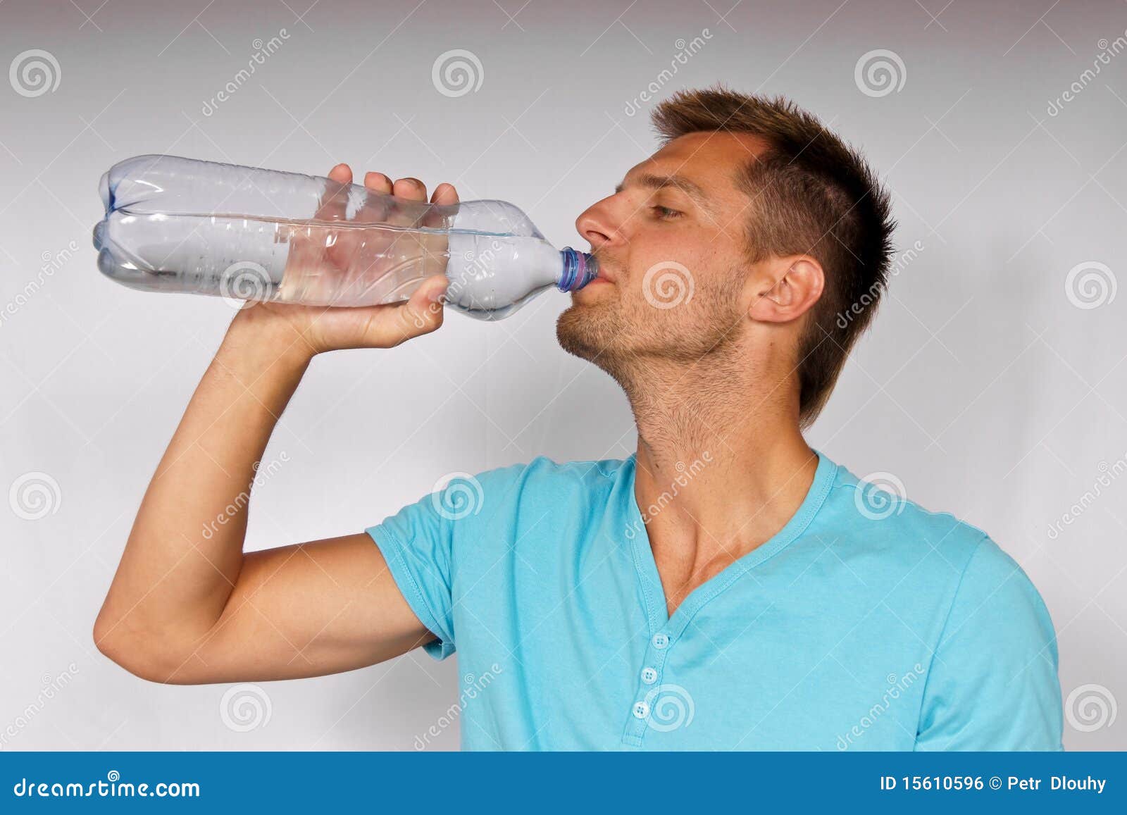 Young man drinking water stock photo. Image of smiling - 15610596