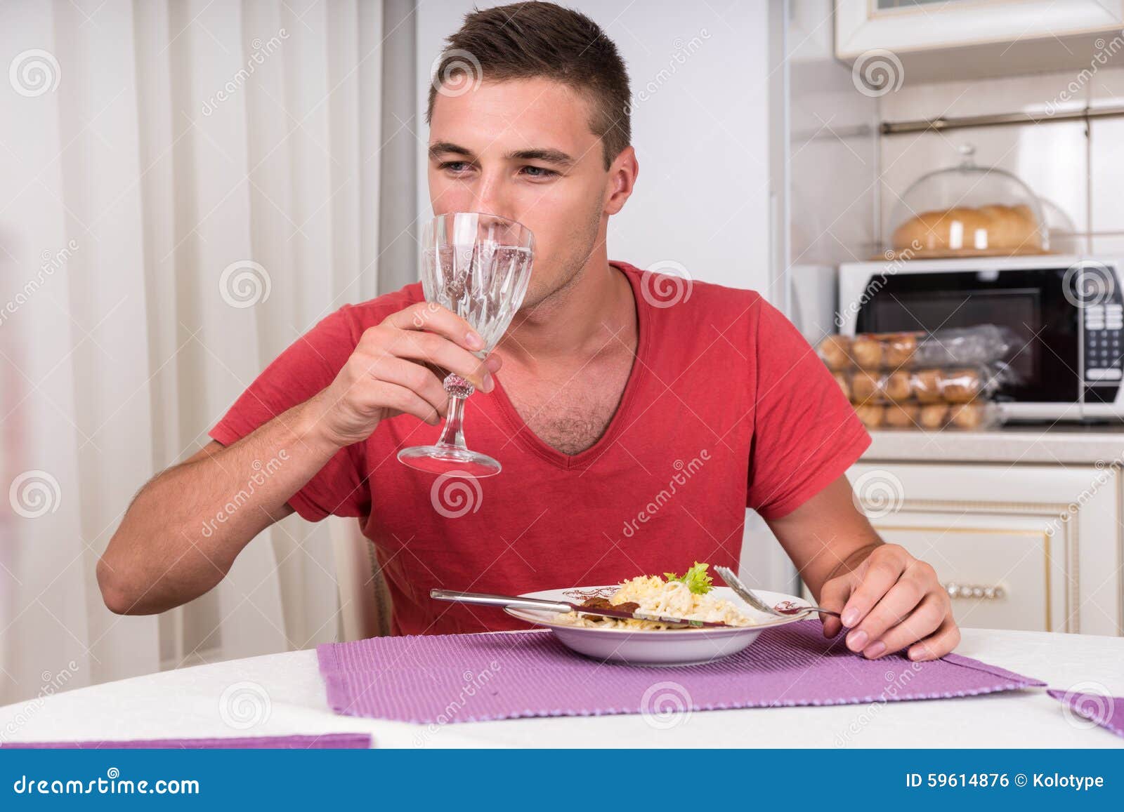 Young Man Drinking Water with Dinner Stock Photo - Image of alone ...