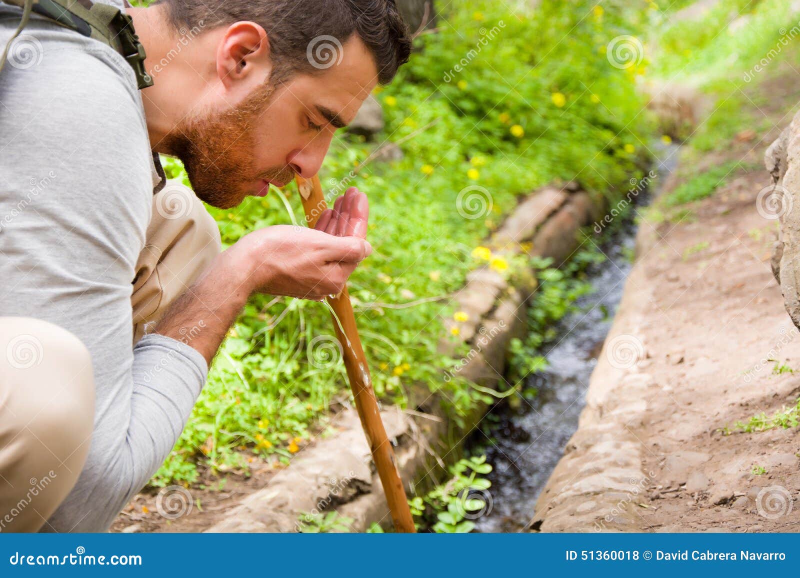 Young Man Drinking Water from a Stream Stock Photo - Image of soil ...