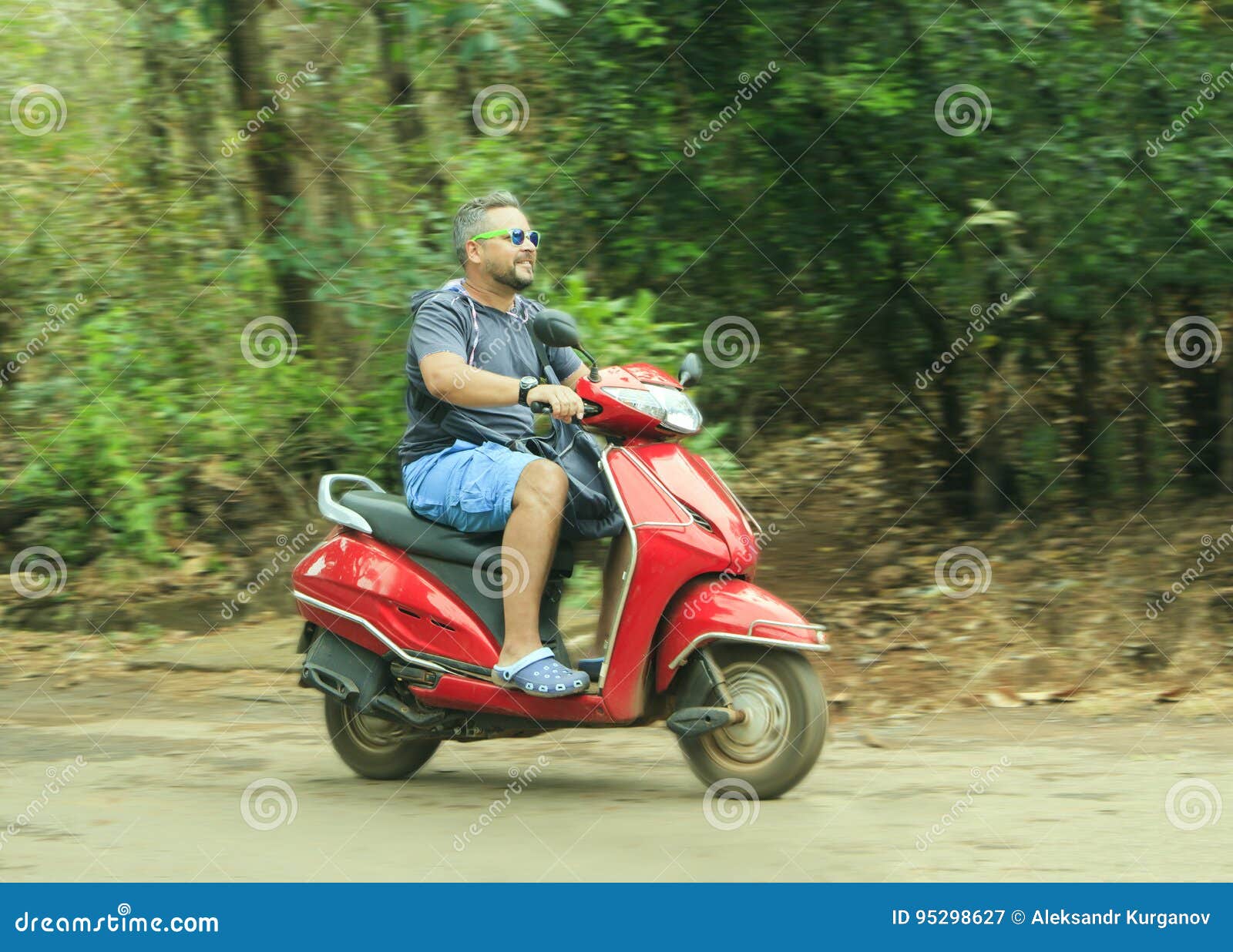 Young Man Drives a Red Motorcycle Stock Image - Image of road, foliage ...