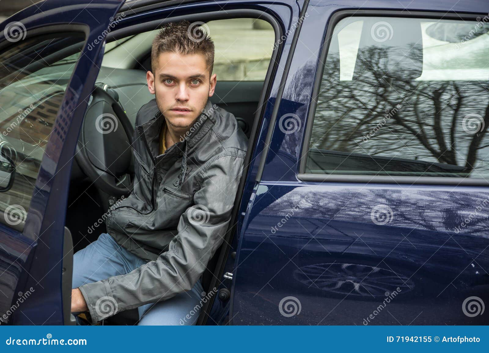 Young man driving car stock image. Image of attention - 71942155
