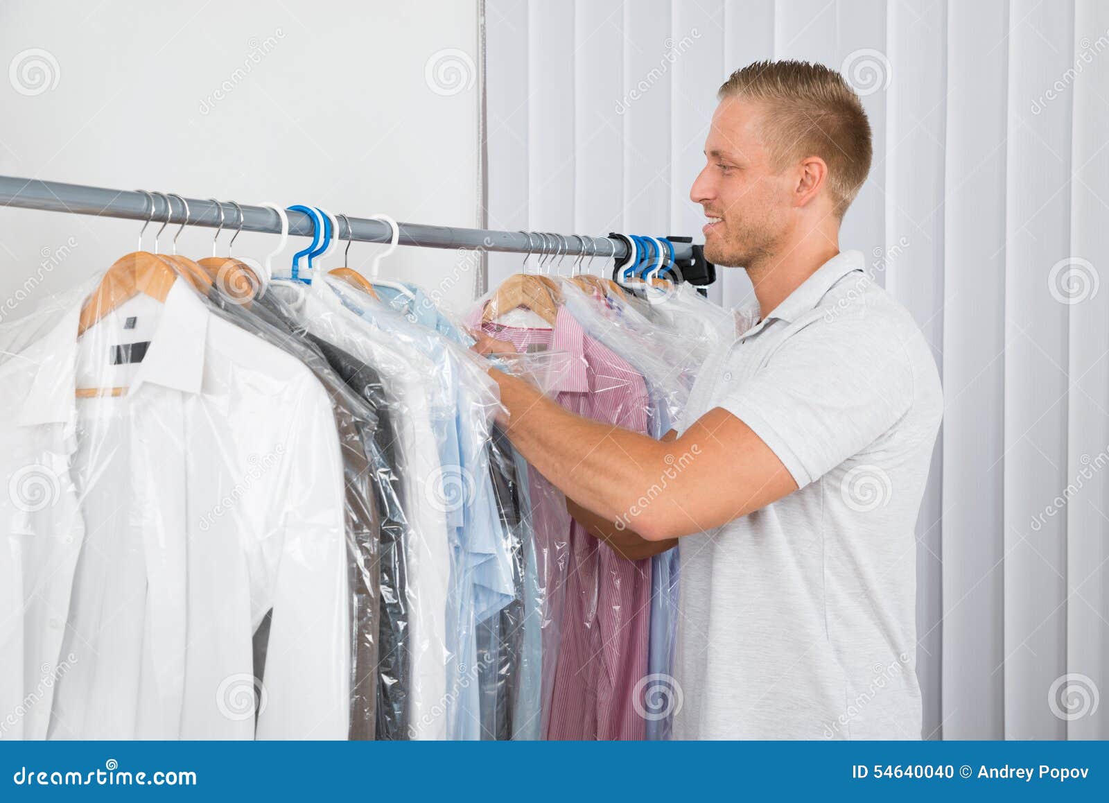 Young Man in Dry Cleaning Store Stock Photo - Image of choice, menswear ...