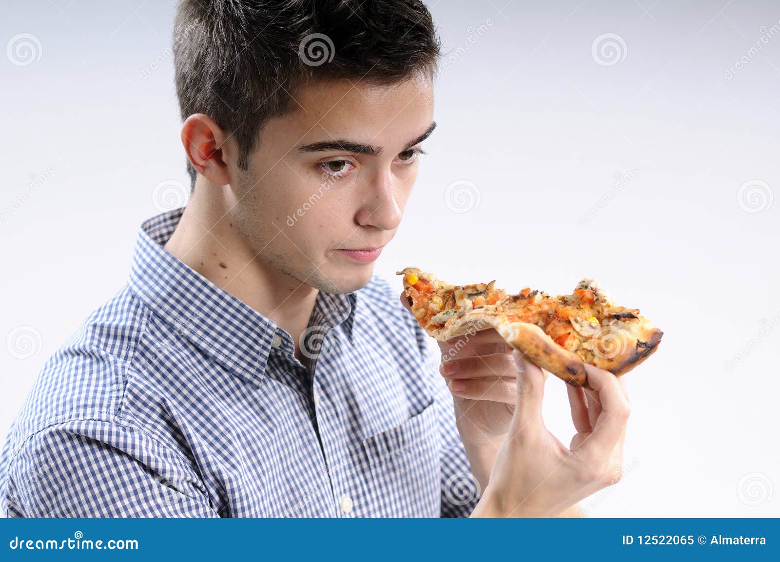 Young man eating stock image. Image of face, looking - 12522065